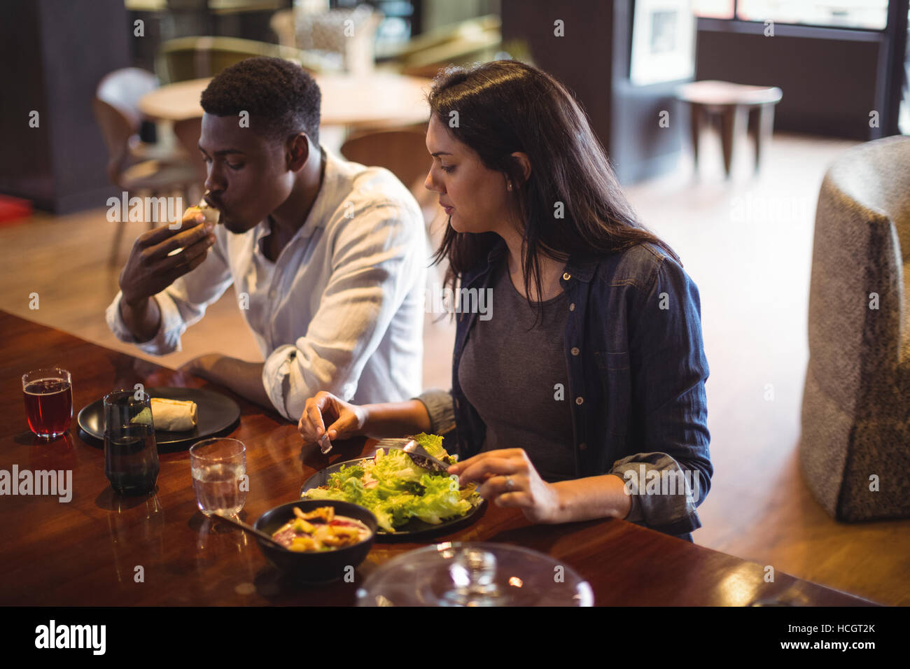 Happy couple having food Stock Photo - Alamy