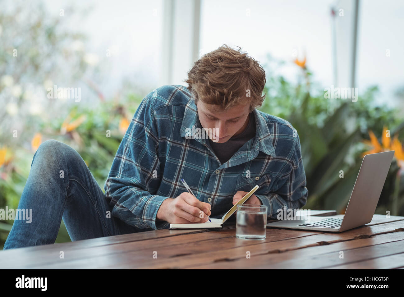 Man writing notes on diary at home Stock Photo - Alamy