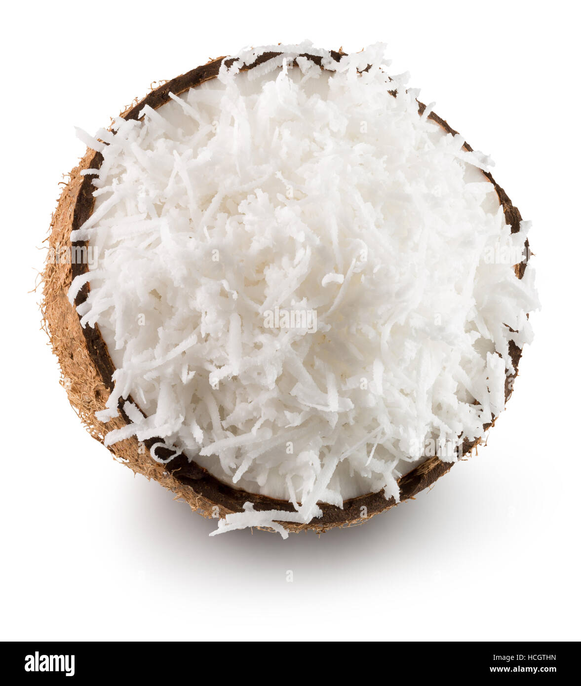 half of coconut with coconut flakes isolated on the white background ...