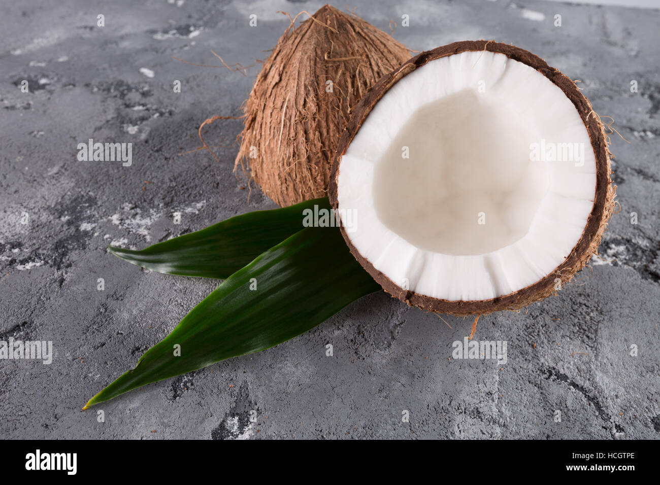 coconuts with leaves on the grey stone background Stock Photo - Alamy