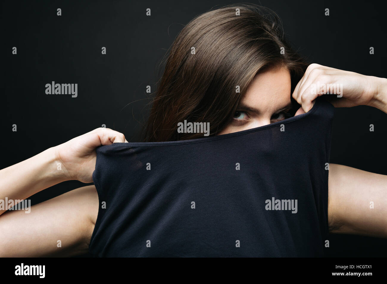 Woman covering her face with cloth Stock Photo - Alamy