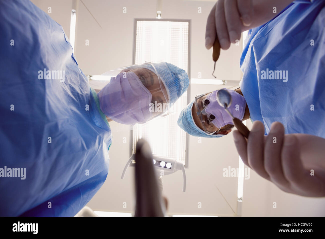 Dentists holding dental tools Stock Photo - Alamy