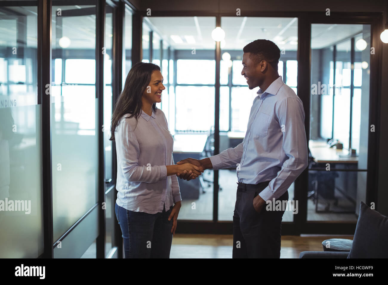 Standing smiling shaking hands communication hi-res stock photography ...