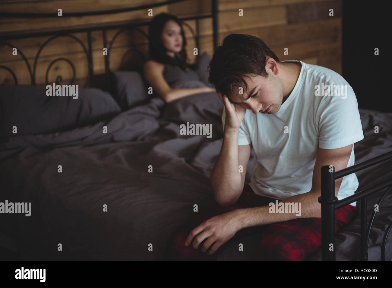 Upset couple ignoring each other after fight on bed Stock Photo - Alamy