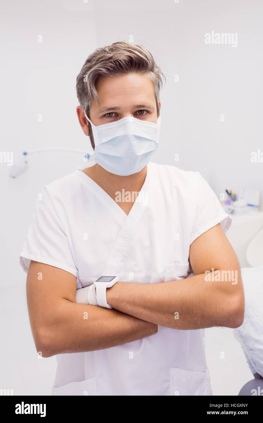 Dentist standing with his arms crossed Stock Photo - Alamy