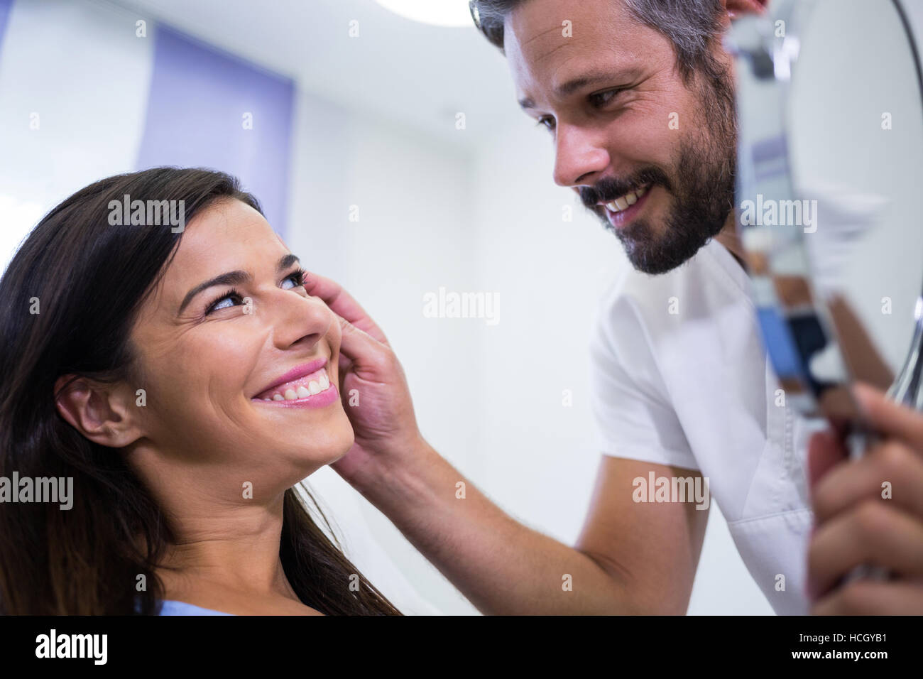 Doctor checking patients skin after cosmetic treatment Stock Photo - Alamy