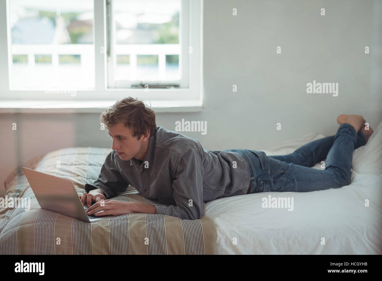 Man lying on bed hi-res stock photography and images - Alamy