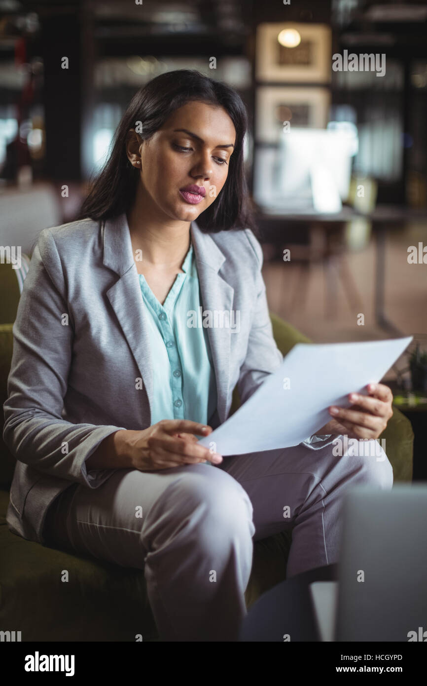 Businesswoman reading document Stock Photo - Alamy