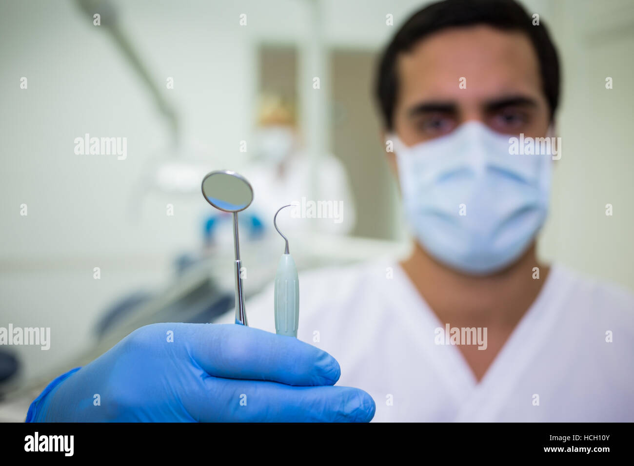 Hand holding dental tools Stock Photo - Alamy