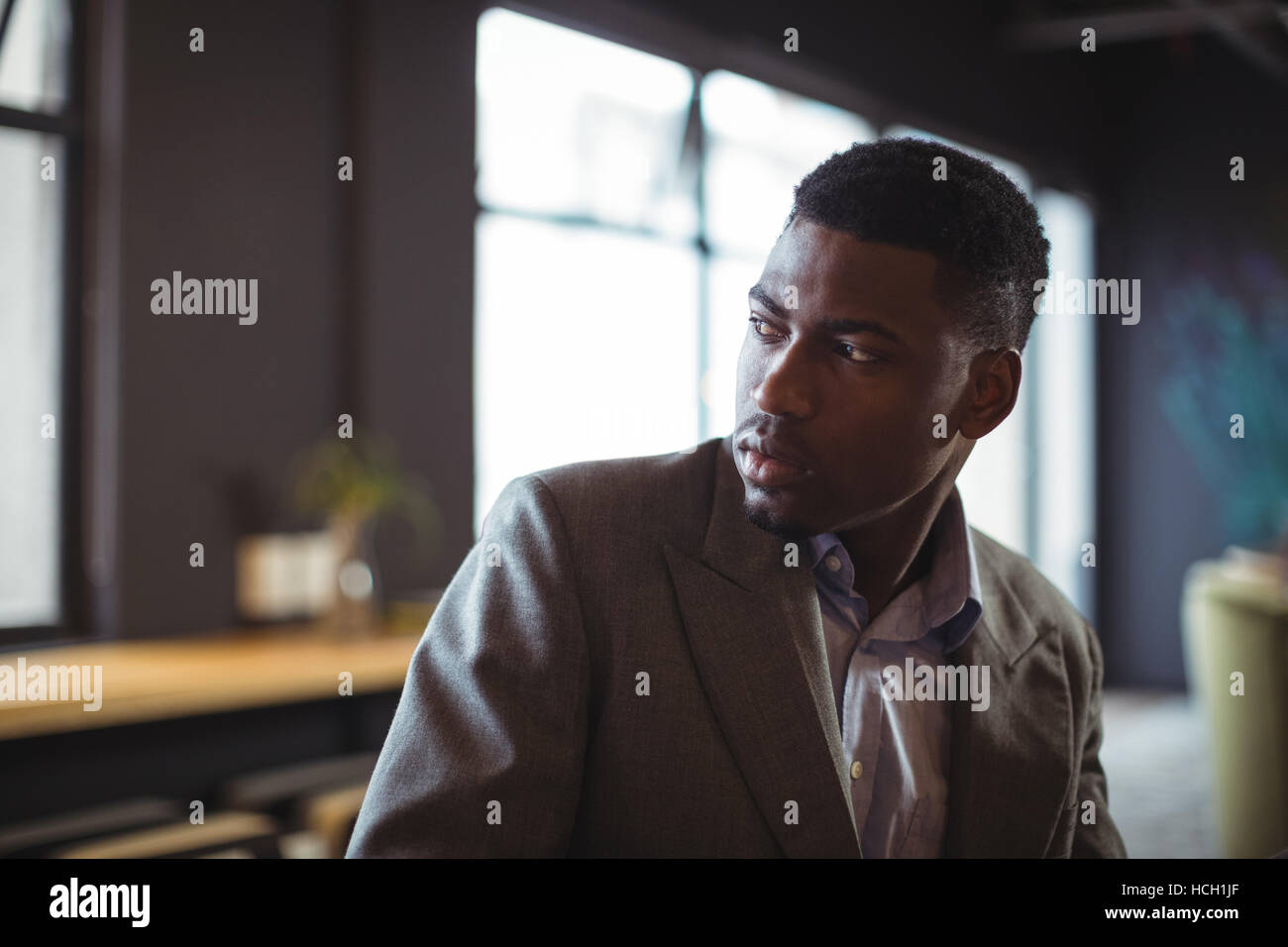 Thoughtful businessman looking away Stock Photo - Alamy
