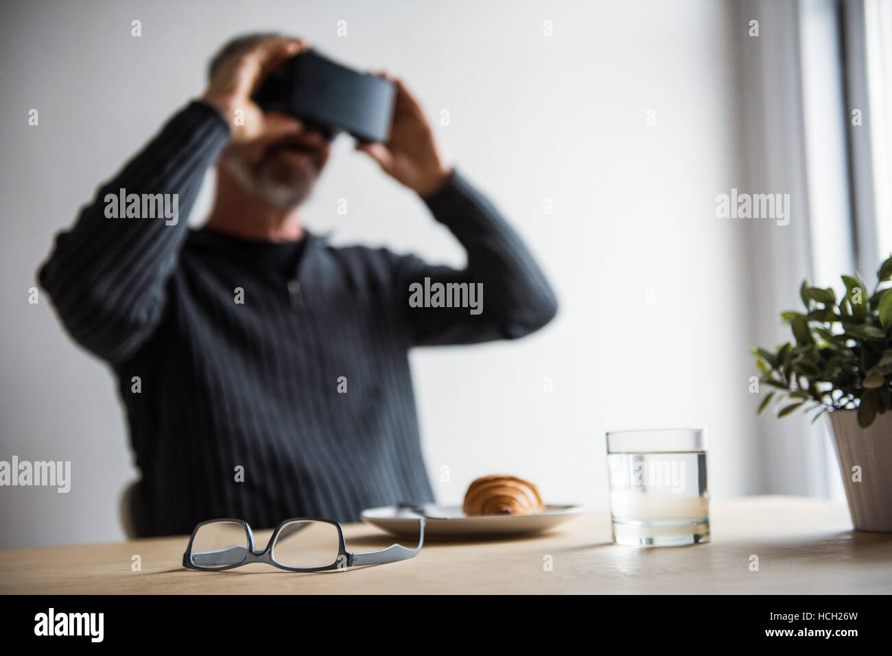 Man using virtual reality headset Stock Photo - Alamy
