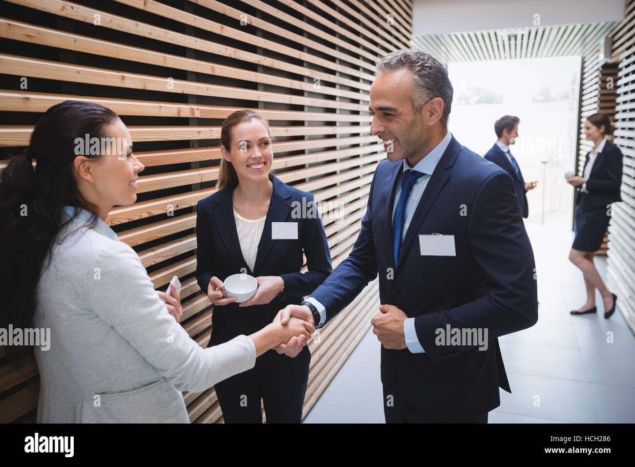 Standing shaking hands smiling communication holding hi-res stock ...