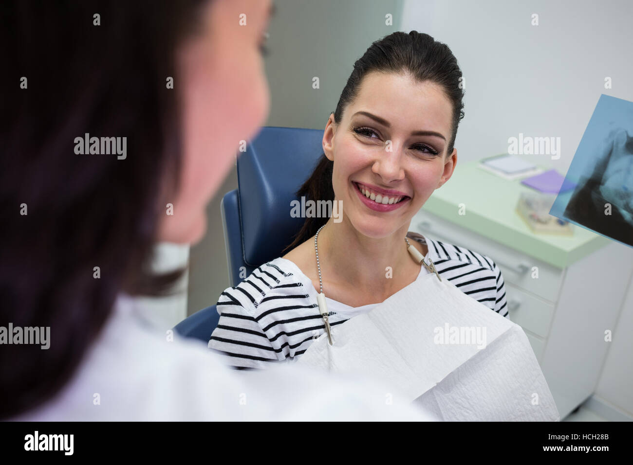 Female patient smiling while talking to doctor Stock Photo - Alamy