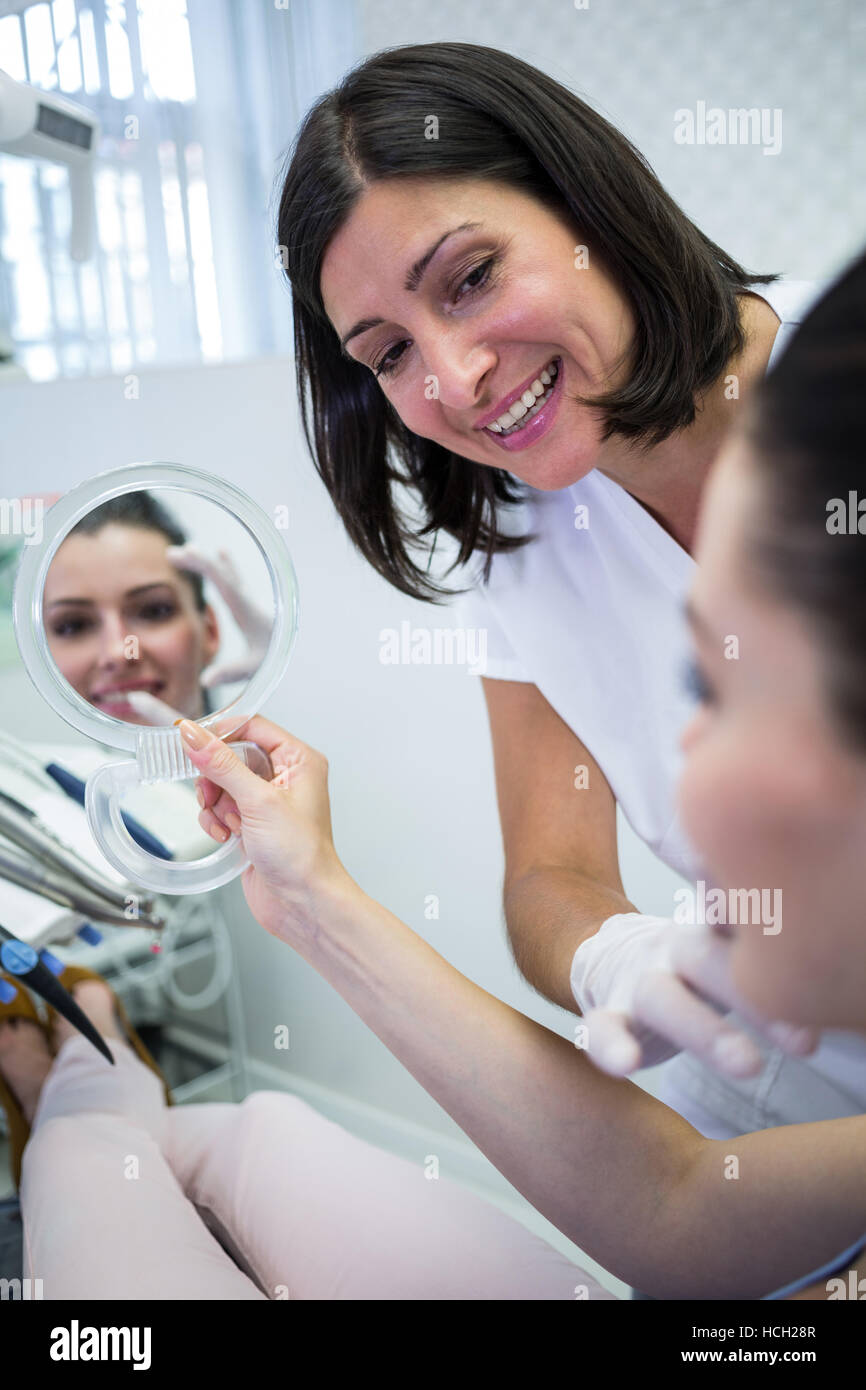 Patient looking at her face in mirror Stock Photo - Alamy