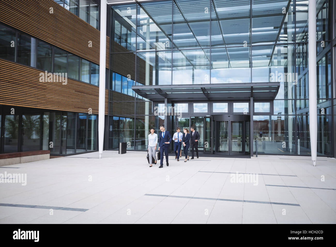Business people walking outside office building Stock Photo - Alamy