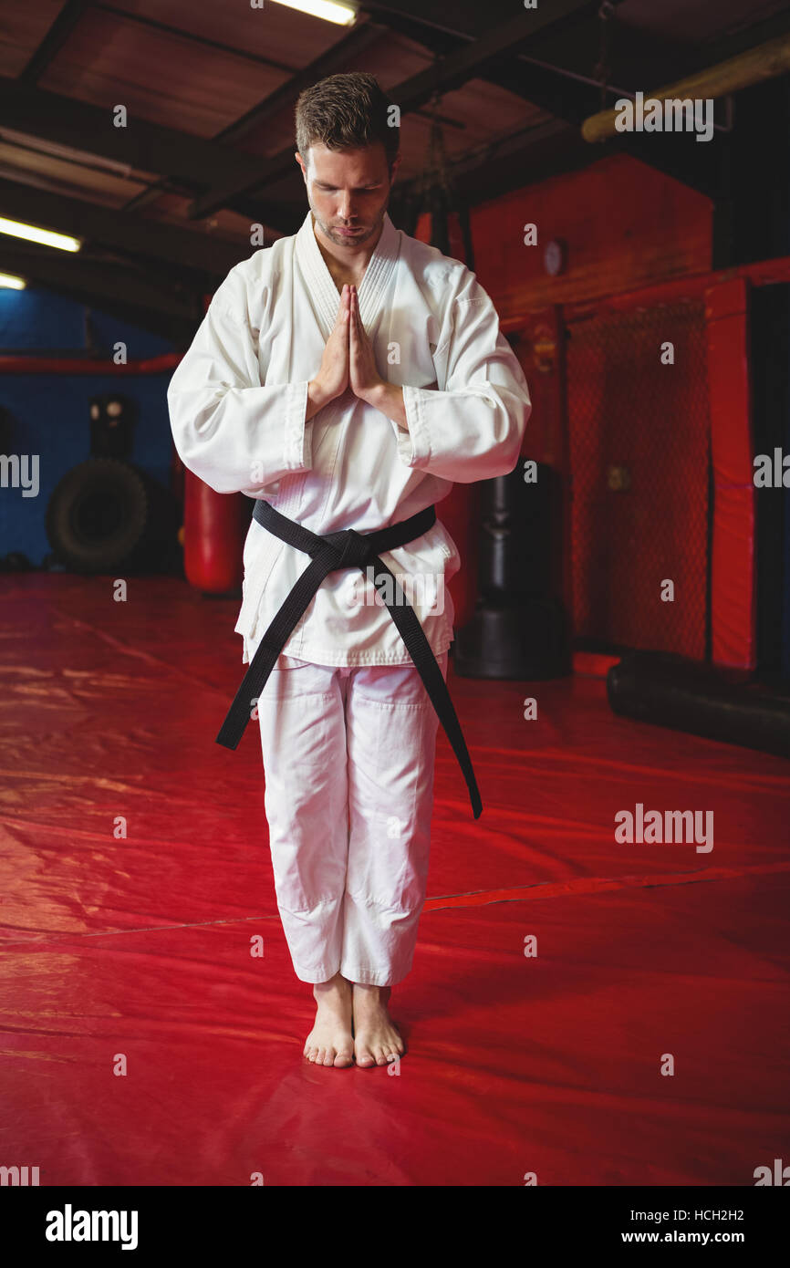 Karate player in prayer pose Stock Photo - Alamy