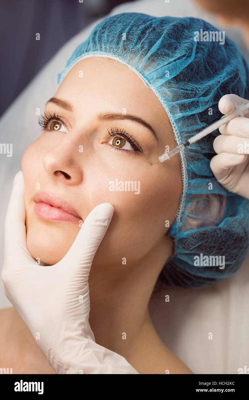 Female patient receiving an injection on her face Stock Photo - Alamy