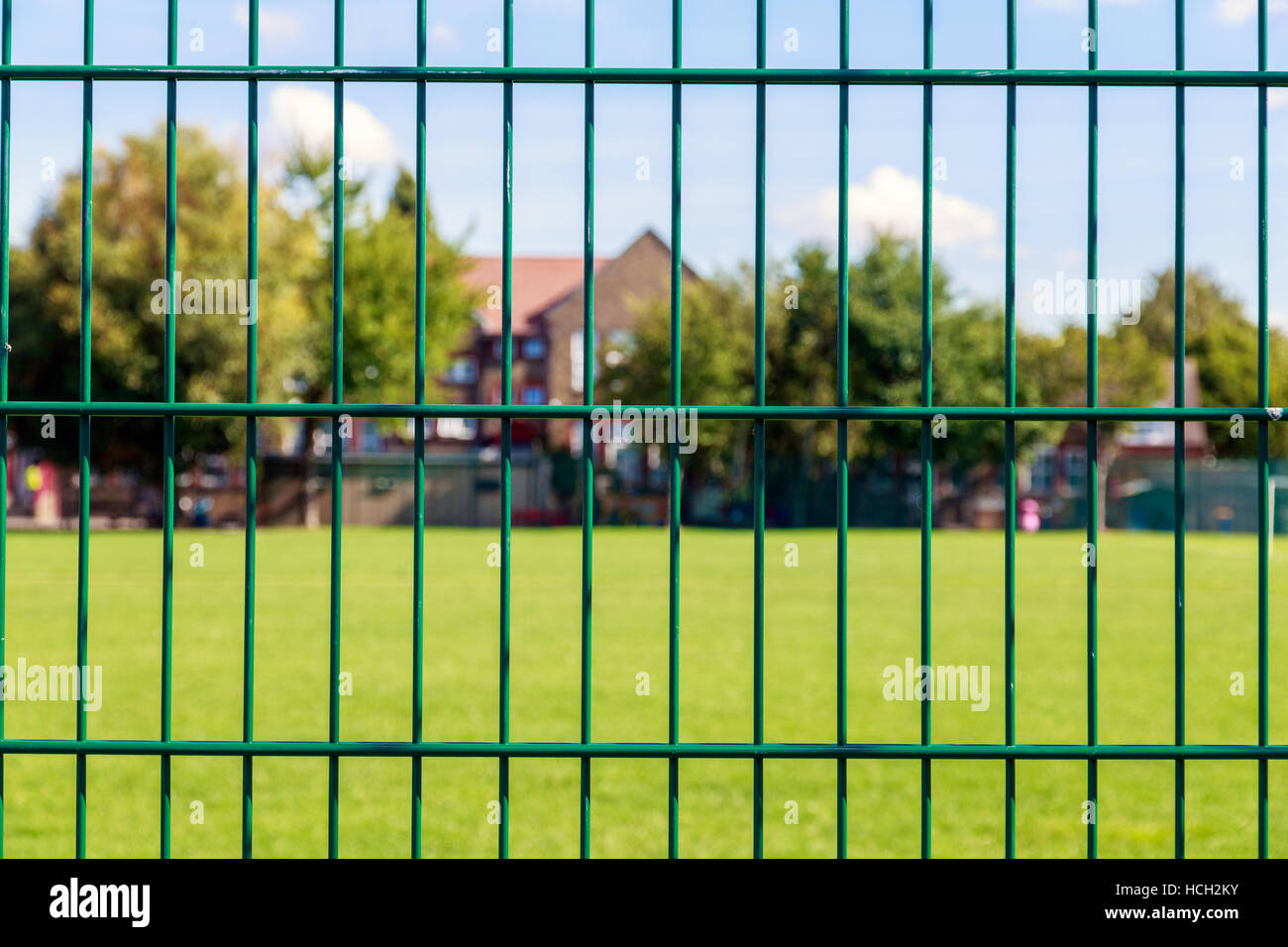 Green fence with house in the background for concept use Stock Photo ...