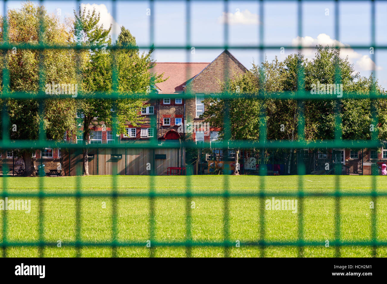 Green fence with house in the background for concept use Stock Photo ...