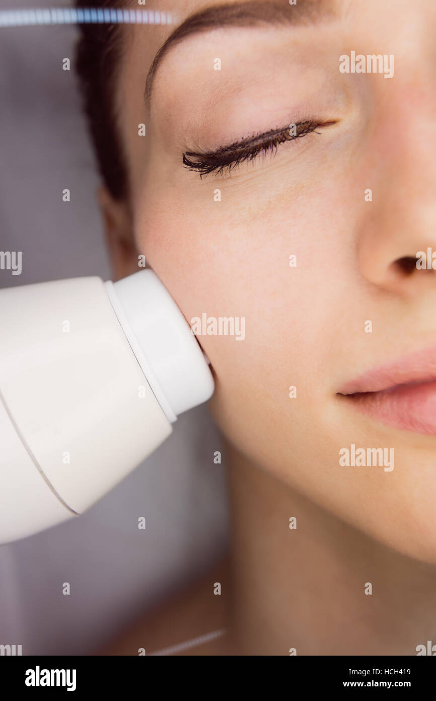 Dermatologist giving facial massage through sonic lifting Stock Photo ...