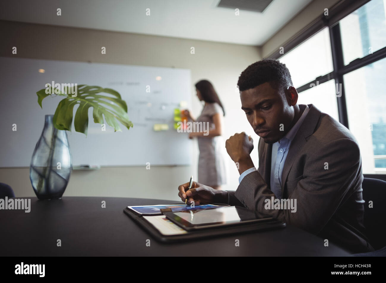 Professional young businessman using pen hi-res stock photography and ...