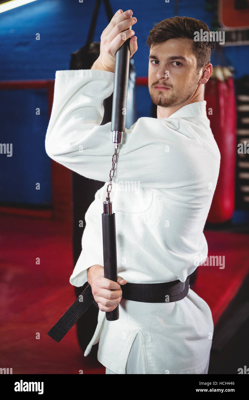 Karate player practicing with nunchaku Stock Photo - Alamy