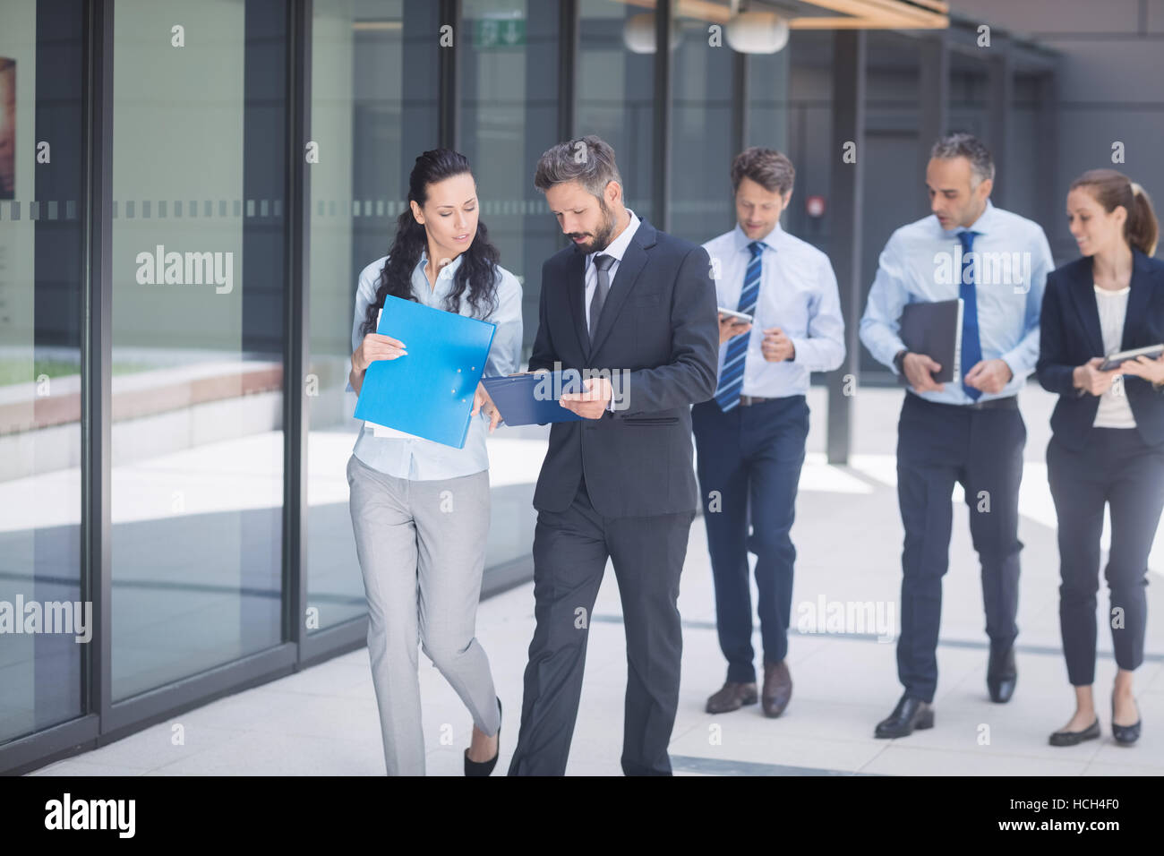 Group of business people walking outside office building Stock Photo ...