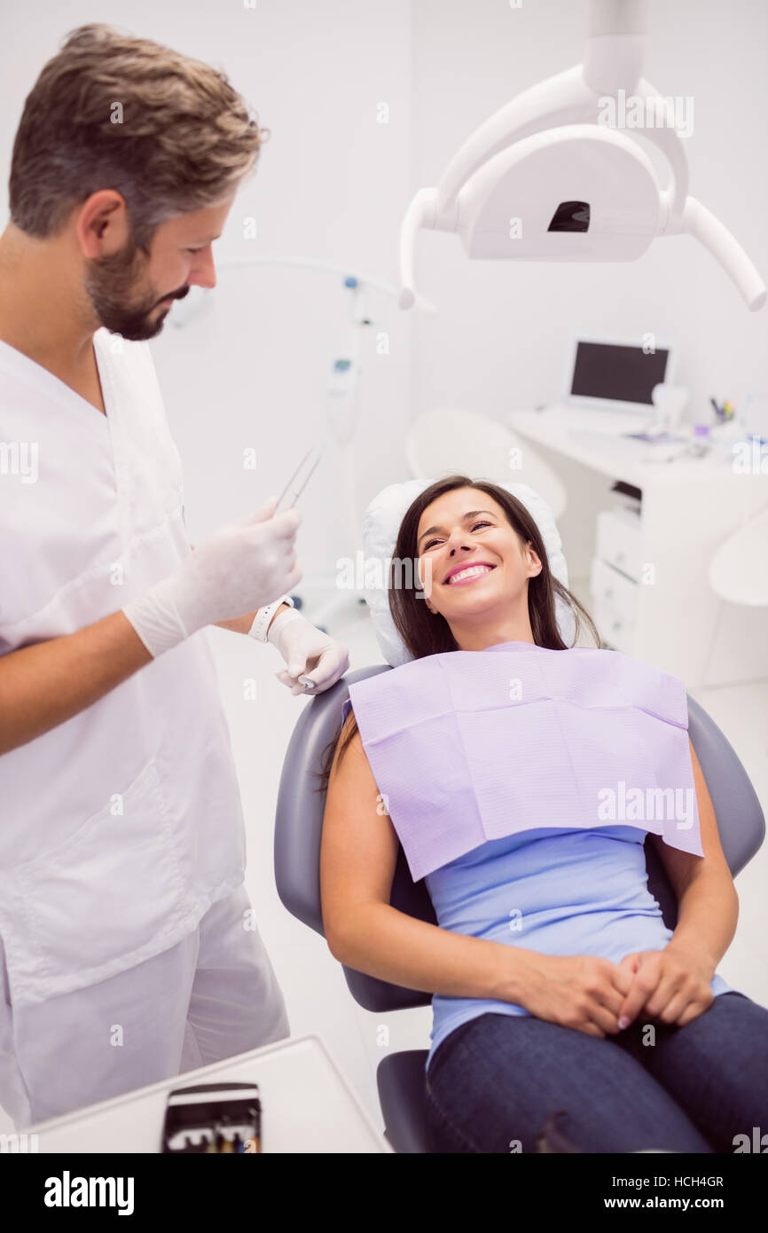 Dentist with smiling female patient Stock Photo - Alamy