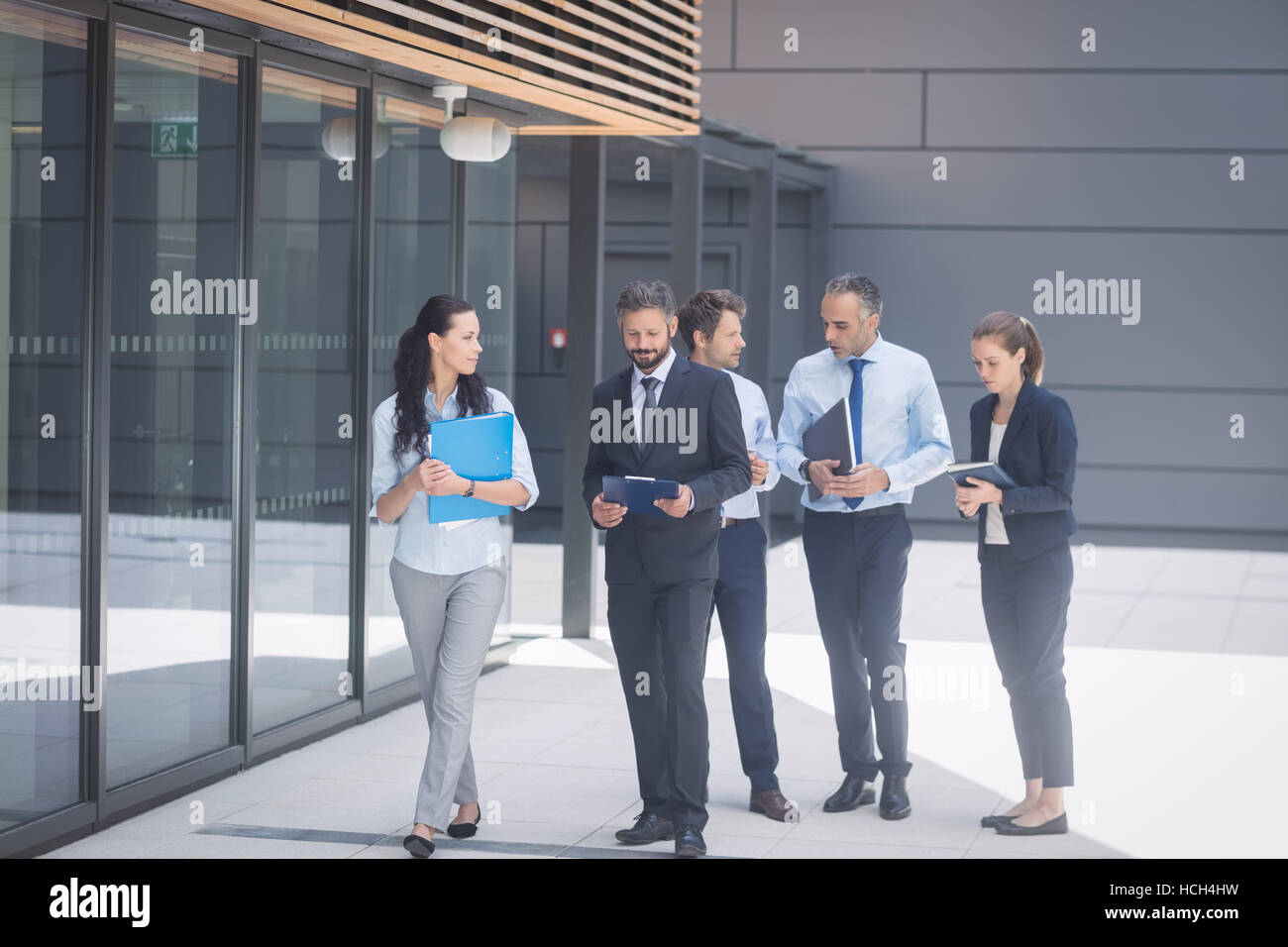 Group of business people walking outside office building Stock Photo ...