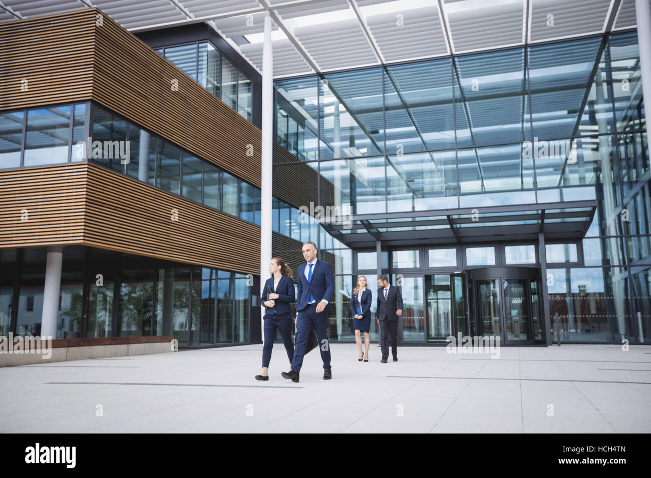 Business people walking outside office building Stock Photo - Alamy