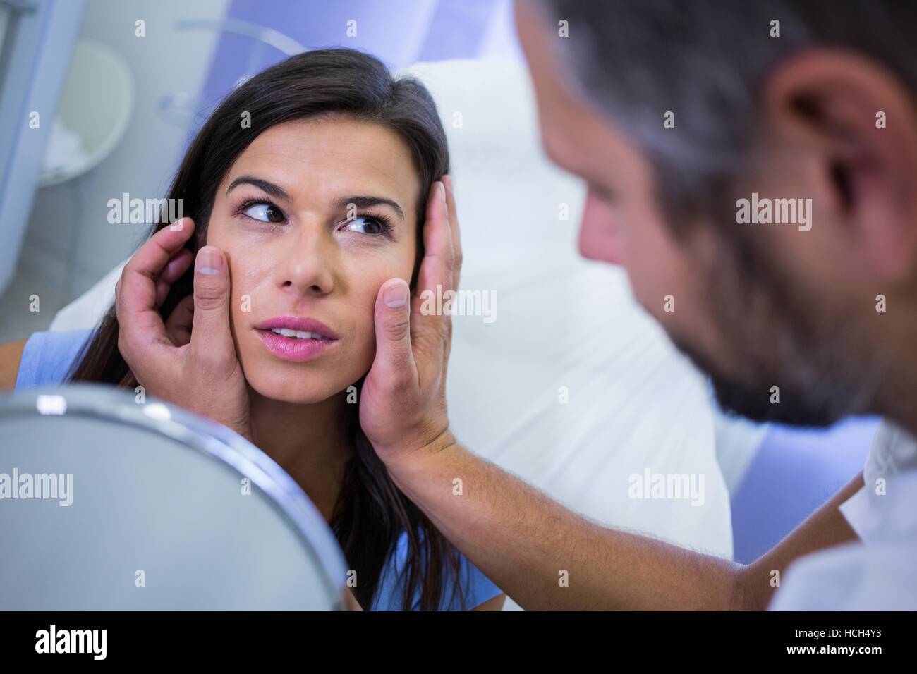 Doctor checking patients skin after cosmetic treatment Stock Photo - Alamy