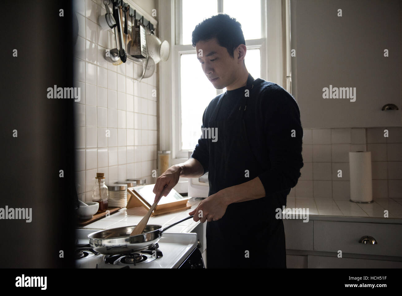 Man preparing food in kitchen Stock Photo - Alamy