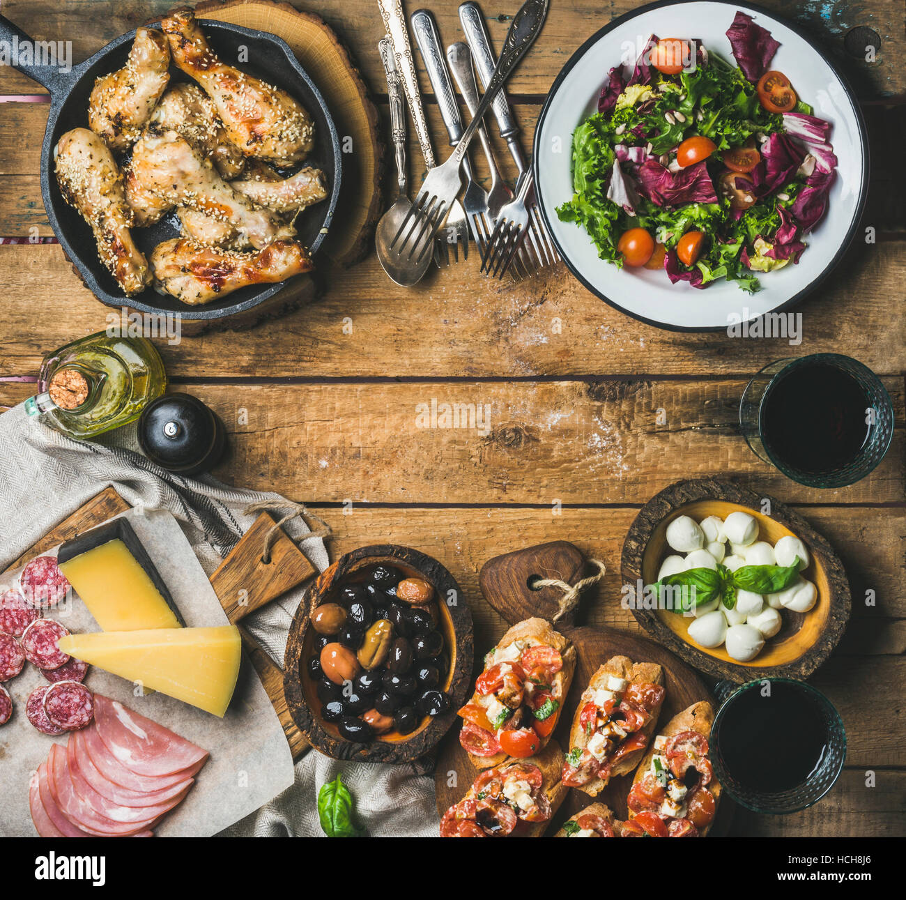 Party table arrangement. Rustic table set with vegetable salad, olives ...