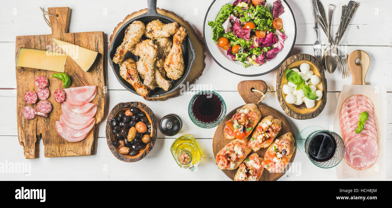 Home dinner table arrangement. Rustic table set with vegetable salad ...