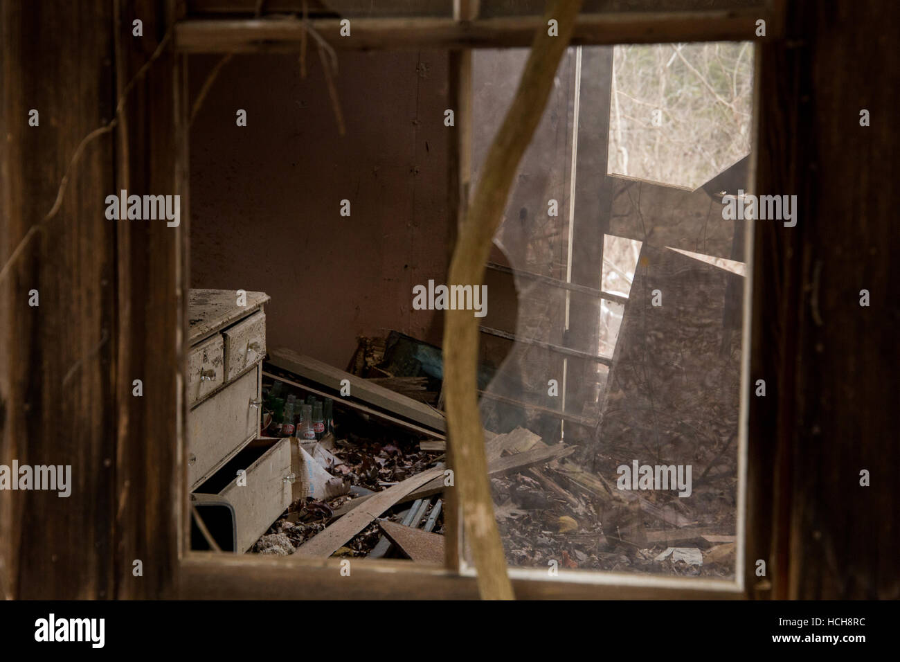 Looking through the broken window pane of an abandoned house with a ...