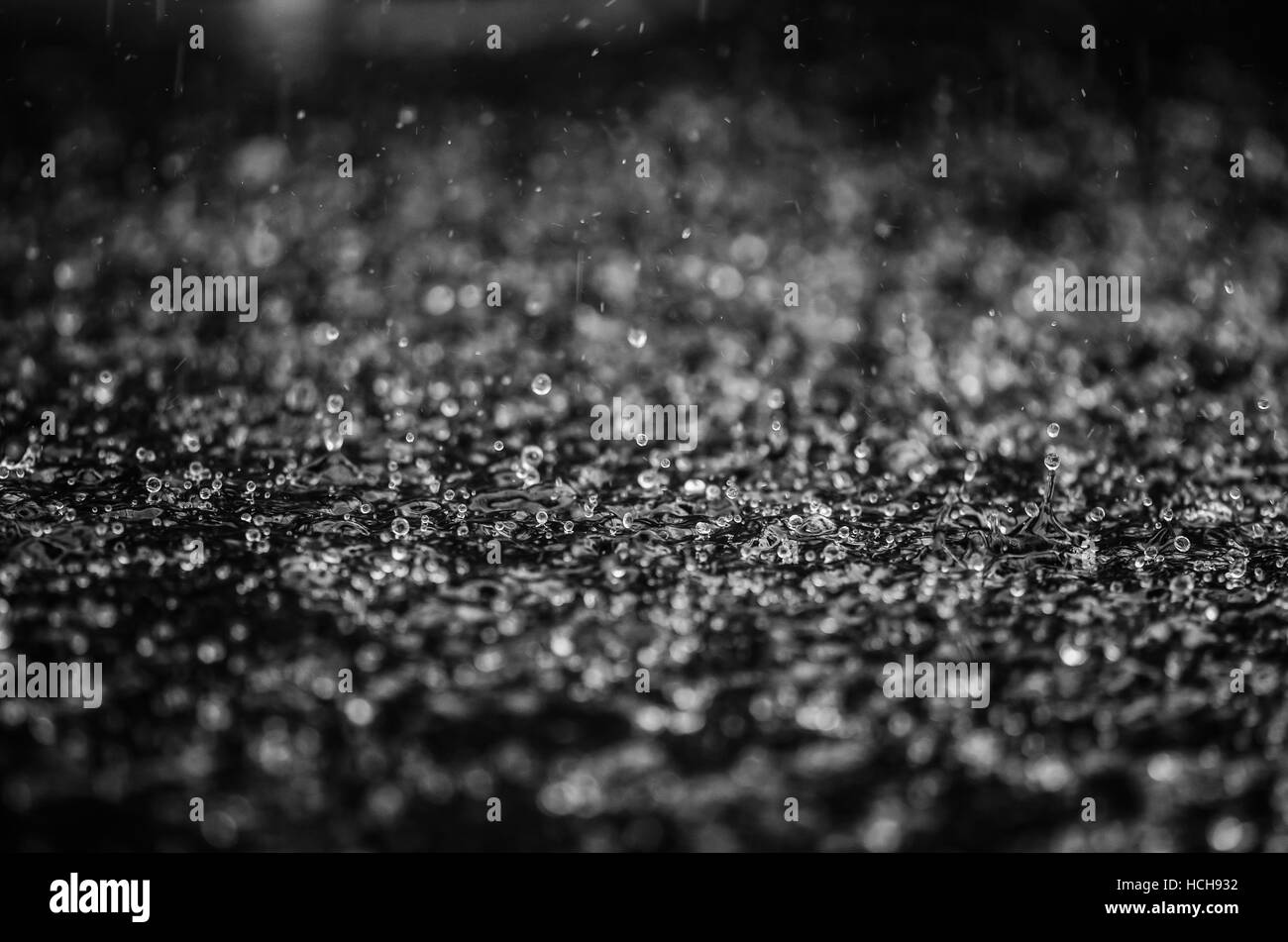 Dark raindrops falling macro close up Stock Photo - Alamy