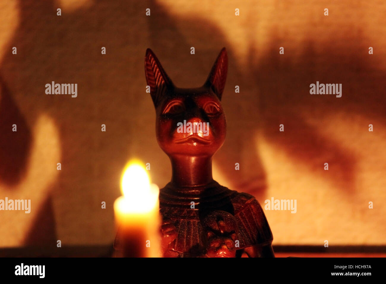 statuette of the goddess Bastet and ritual candle on the altar Stock ...