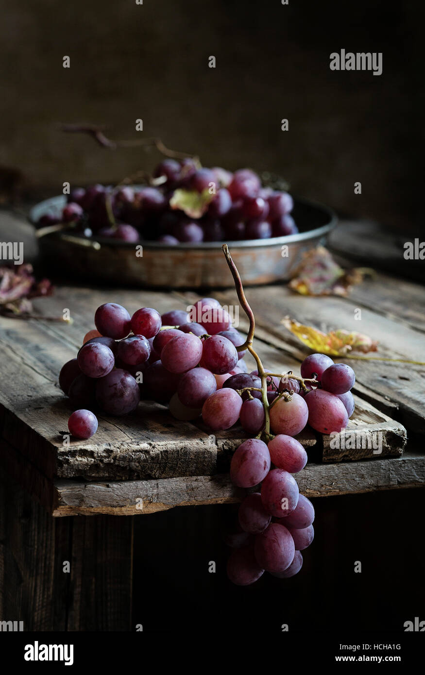 Fresh bunch of red grapes on wooden table Stock Photo - Alamy