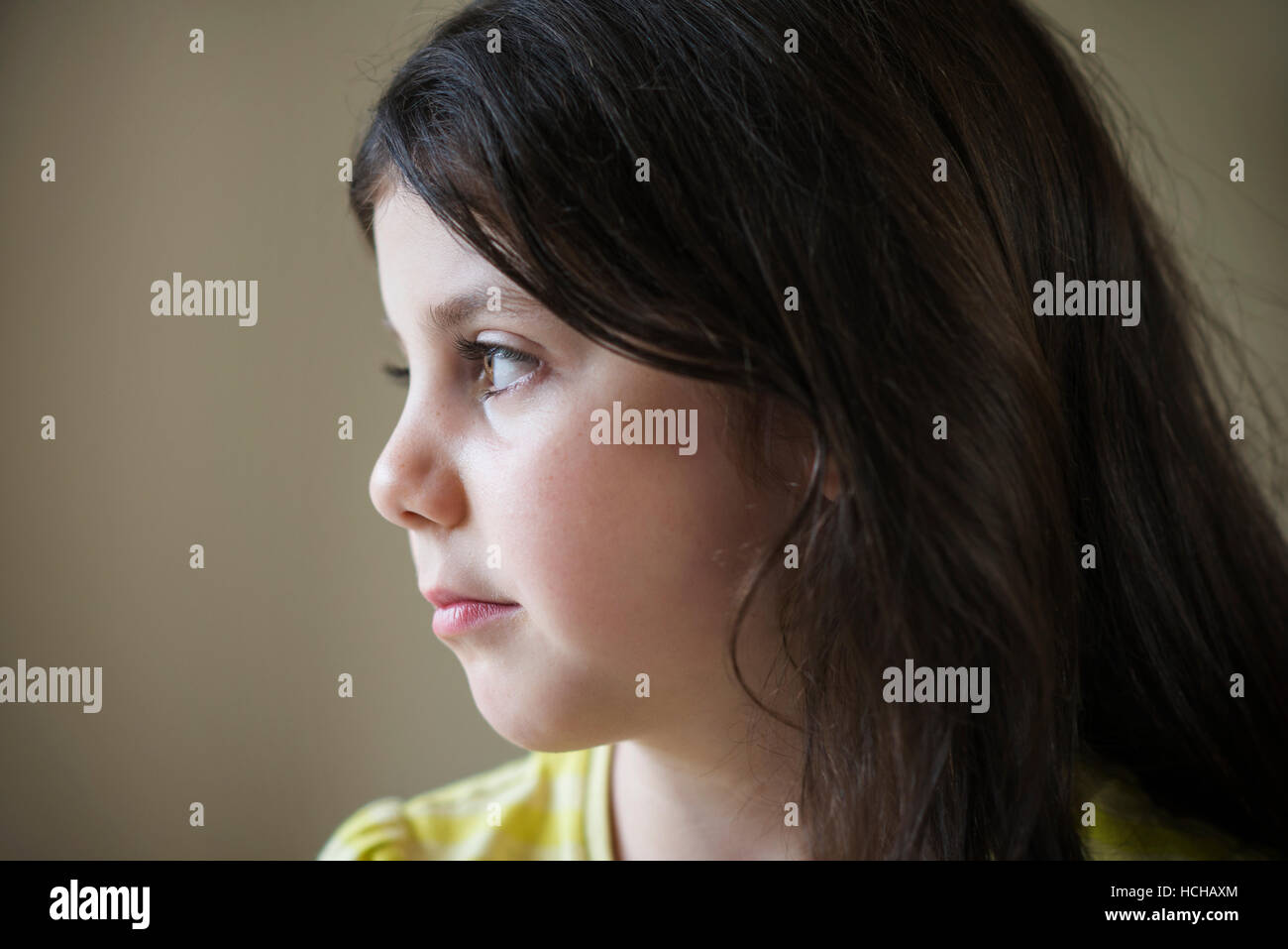 reflective sad looking young girl staring into the distance Stock Photo ...