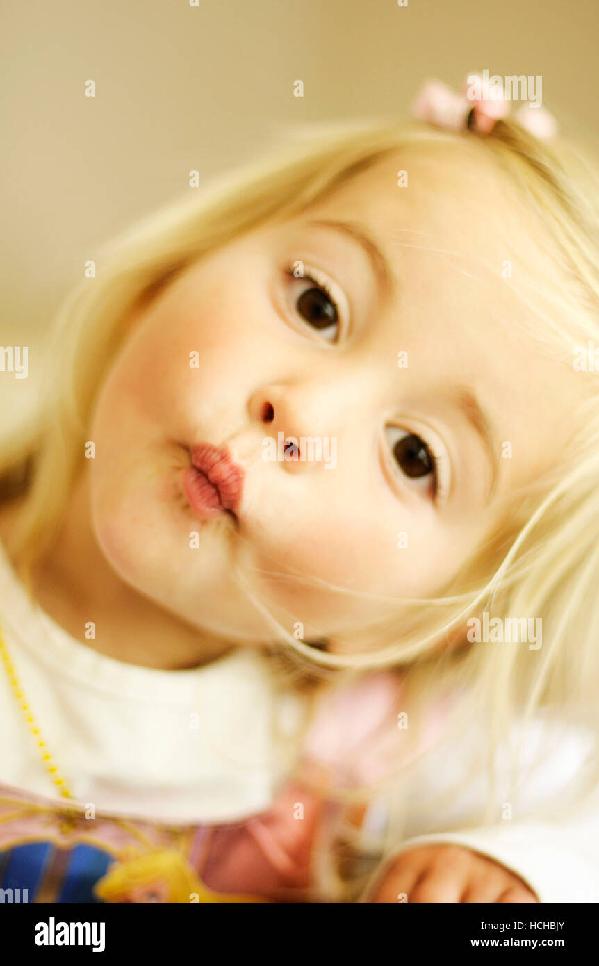 a young girl puckering up to give a kiss Stock Photo - Alamy