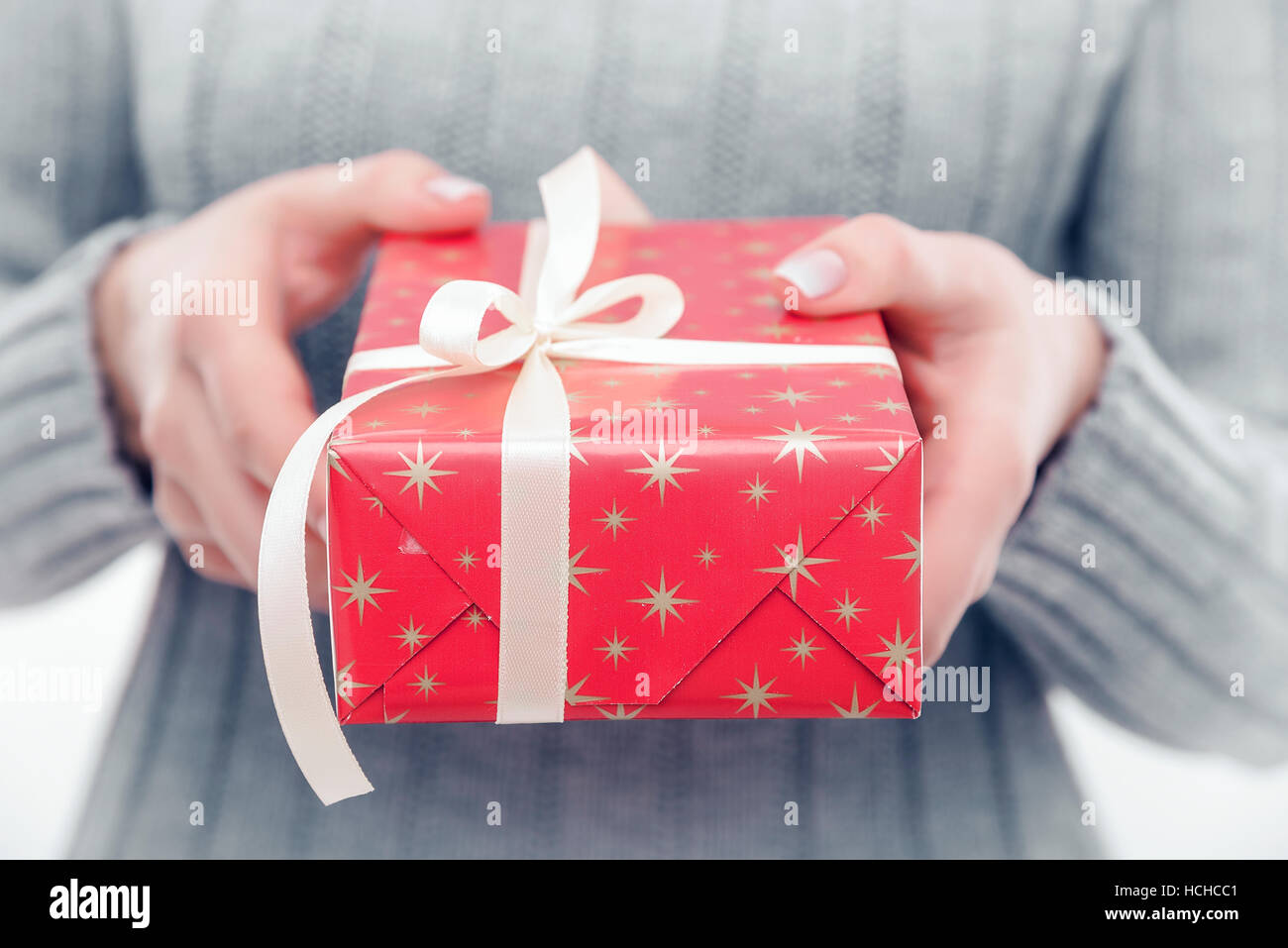 Female hands holding a gift box Stock Photo - Alamy