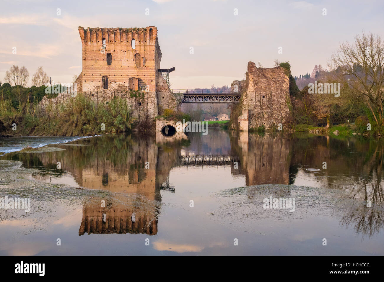 Reflections of ancient bridge in water of Mincio River at Borghetto ...