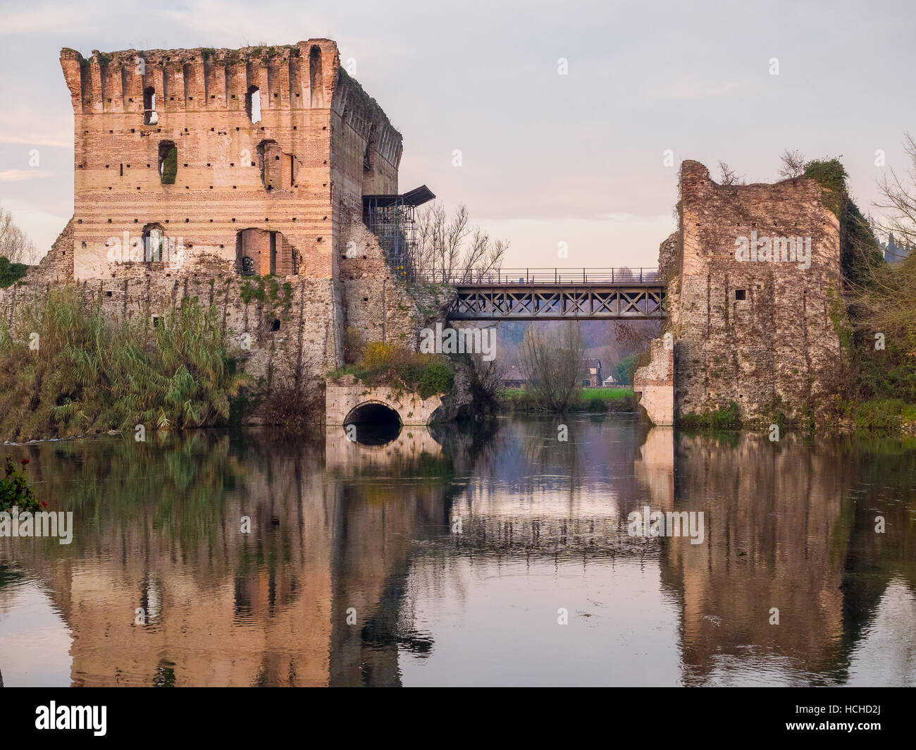 Reflections of ancient bridge in water of Mincio River at Borghetto ...