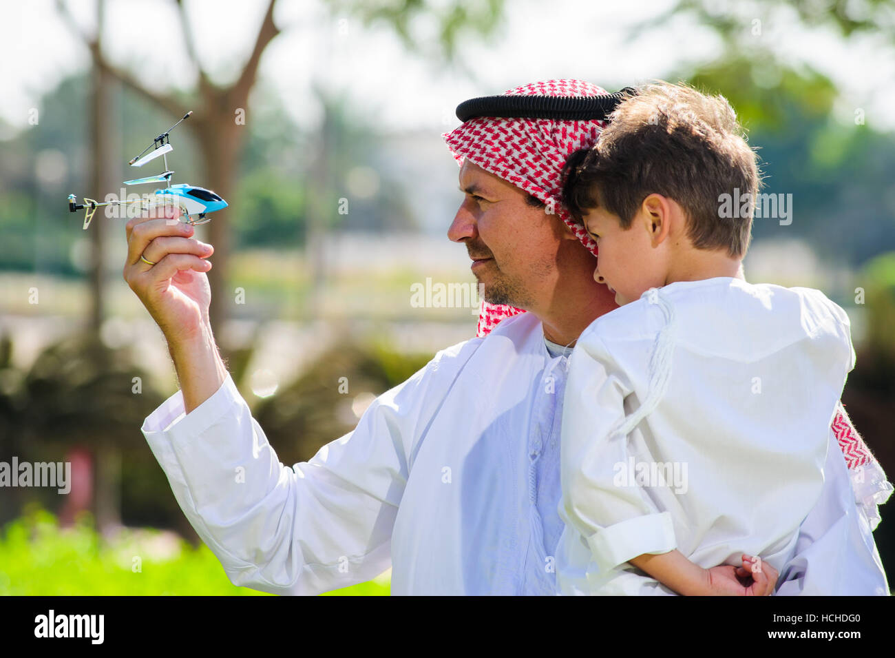 Middle eastern father and son playing with toy plane Stock Photo - Alamy