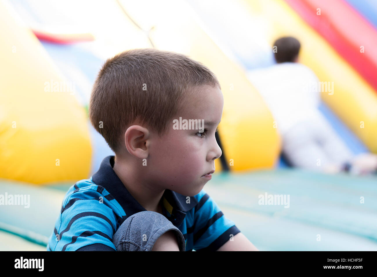 Sad little boy at kids playground Stock Photo - Alamy