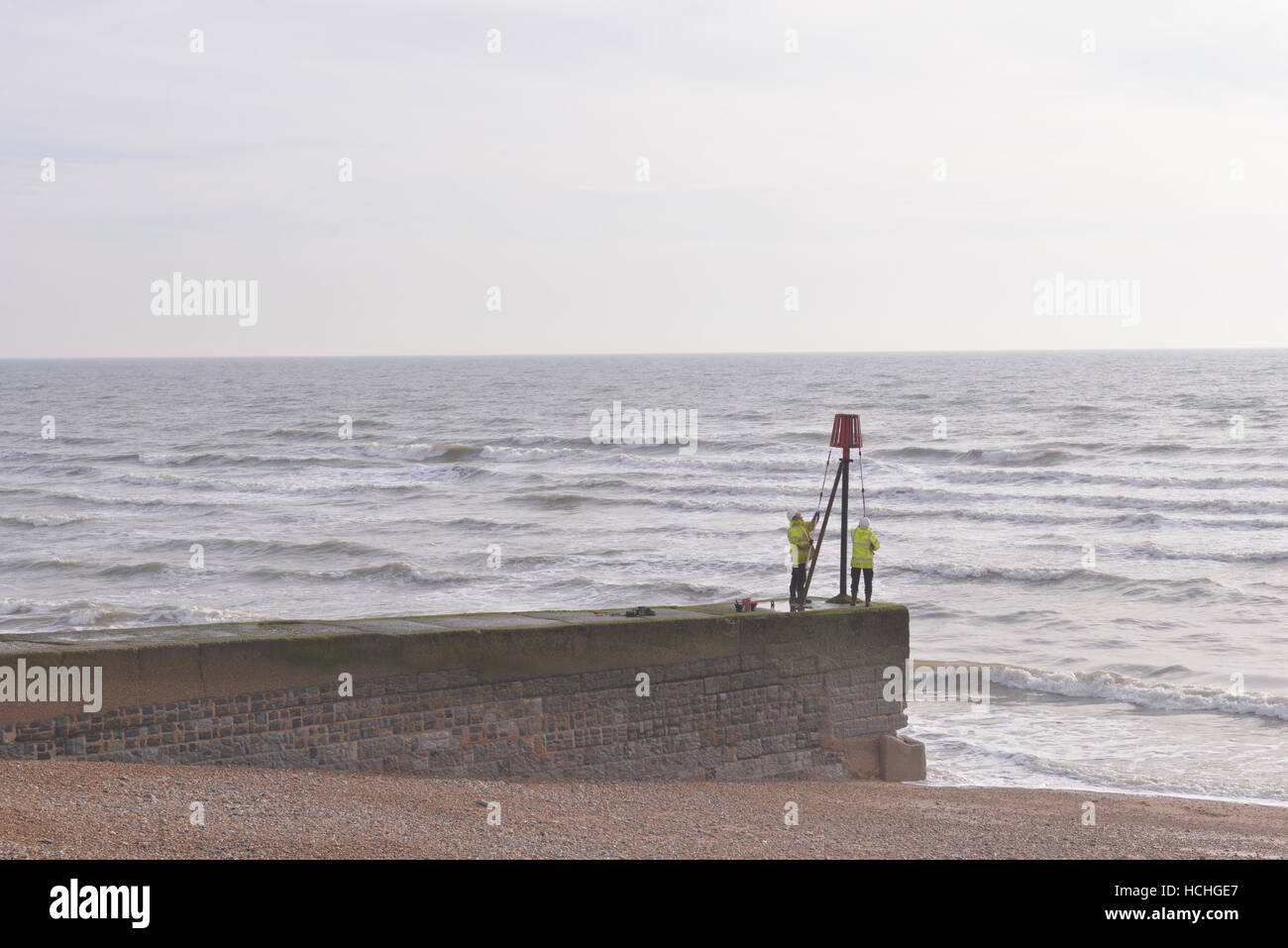 Maintenance workers painting sea marker, St Leonard's-on-sea UK Stock ...