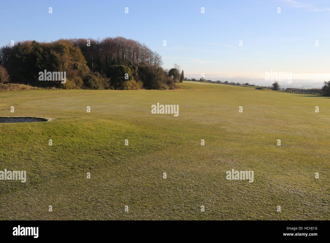 A fairway on a golf course during the early morning sunshine in ...