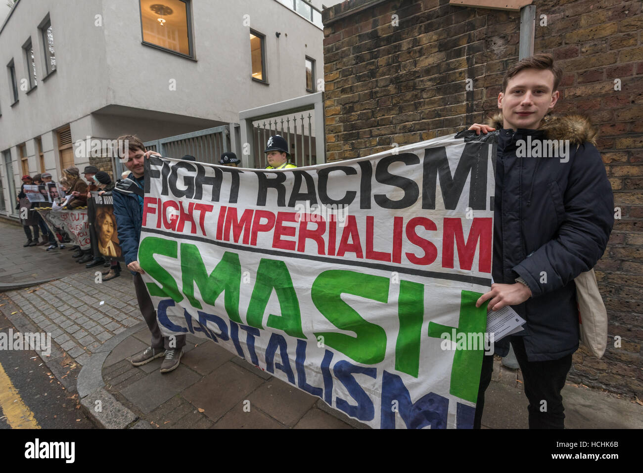 London, UK. 8th December 2016. People hold a banner from 'Fight Racism ...