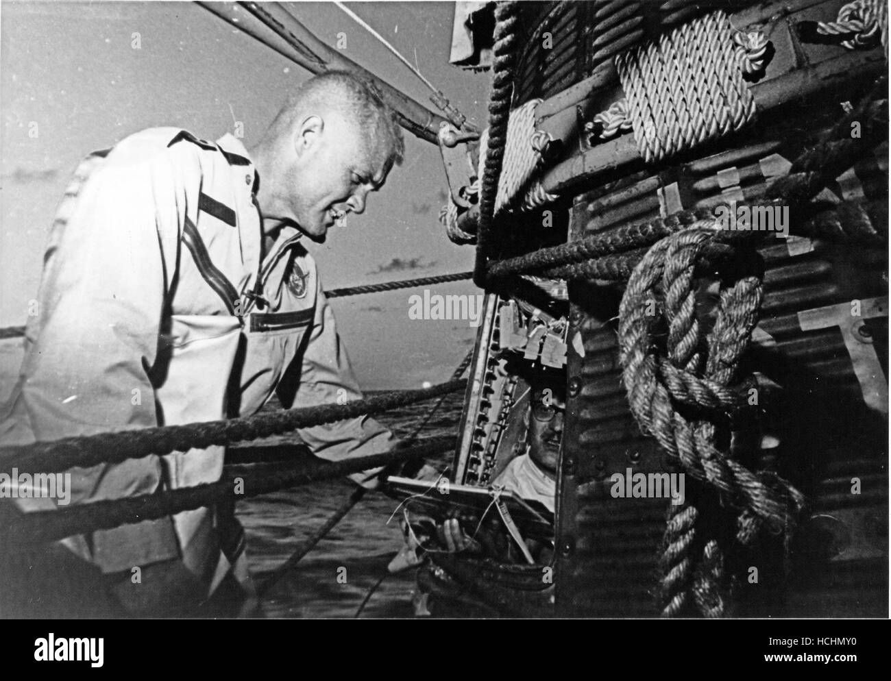 Astronaut John H. Glenn, Jr. checks the Friendship 7 spacecraft after ...