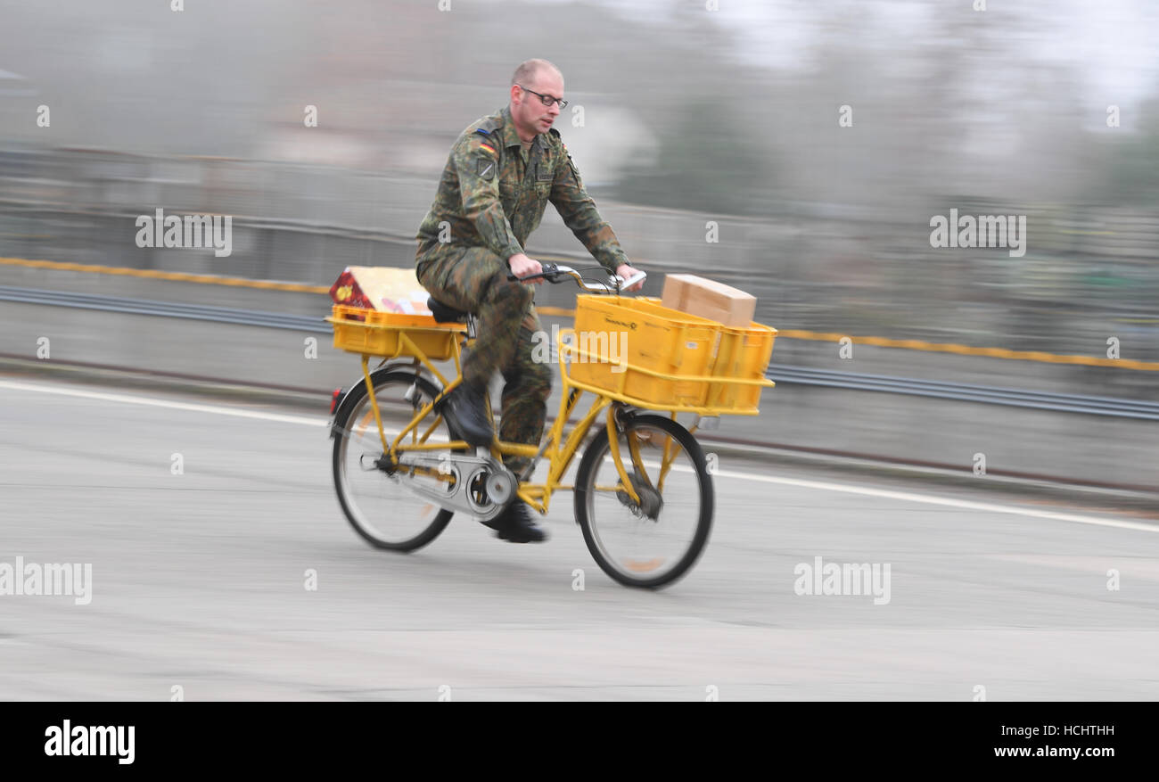 Hauptgefreiter Torsten Weidenfelder rides an army postal service bike ...